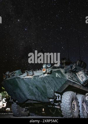 A Marine Corps LAV-25 light armored vehicle rolls past a desert landing ...