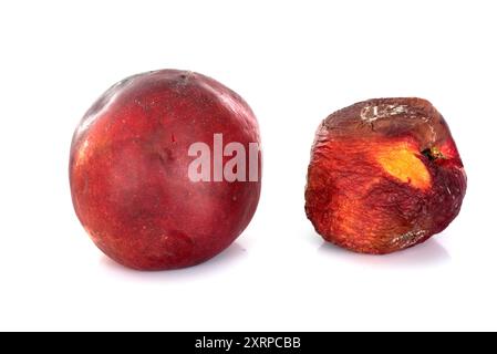 rotten and fresh nectarines in front of white background Stock Photo ...