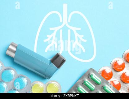 Asthma inhaler, drugs and illustration of lungs on pink background ...