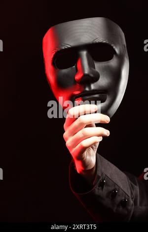 Theatrical performance. Man with plastic mask on black background ...