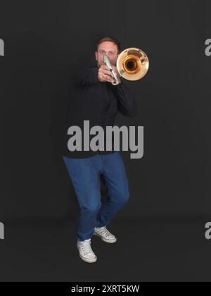 handsome young man with trombone on white background Stock Photo - Alamy