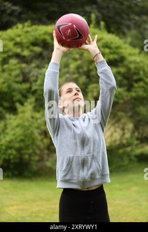 Girl playing netball practising shooting - sport aiming aim accuracy ...