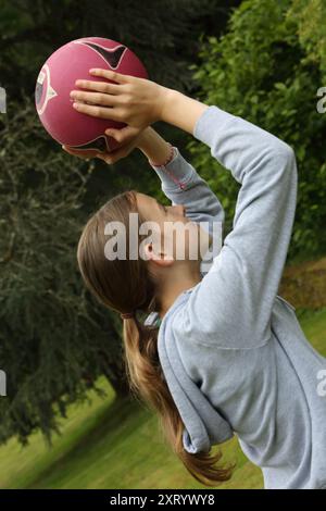 Girl playing netball practising shooting - sport aiming aim accuracy ...