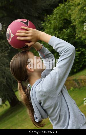Girl playing netball practising shooting - sport aiming aim accuracy ...