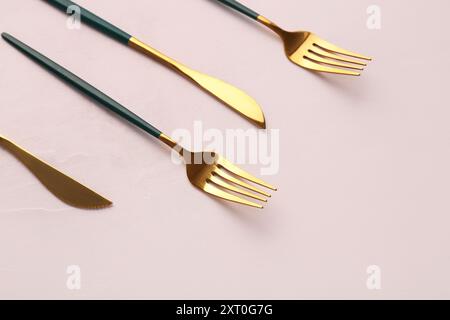 Golden forks and knives with green handles on white background Stock ...