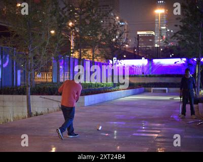 Chinese man whipping spinning tops, a traditional Chinese game in which ...