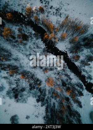 Aerial view of a meandering river cutting through a desolate, sandy ...