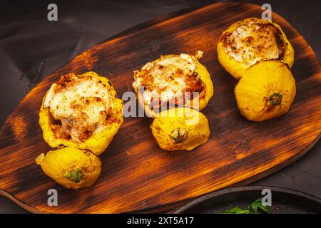 Wooden board with tasty stuffed pumpkins on black background Stock ...