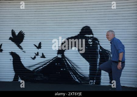 Sir Jim Smith poses in front of Banksy's final work in a series of 9 ...