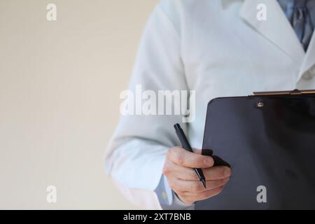 Medical professional taking notes Stock Photo - Alamy