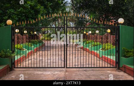 Metal driveway rural property entrance gates set in brick fence with ...