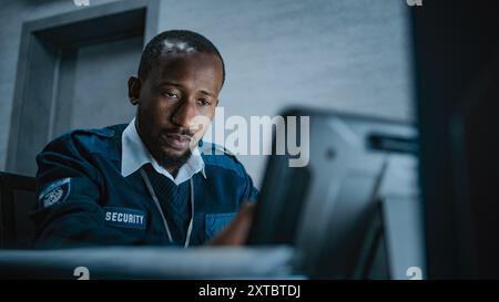 Male African-American CCTV Operator Monitors Multiple Screens For ...