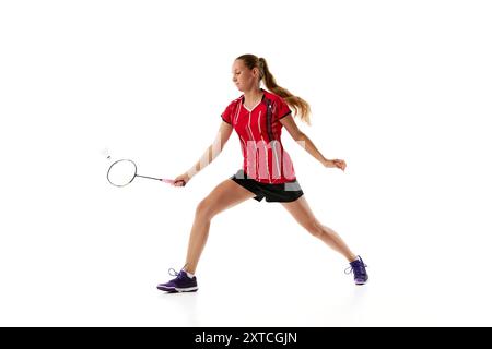 Young woman, badminton athlete leaping in motion, ready to hit ...