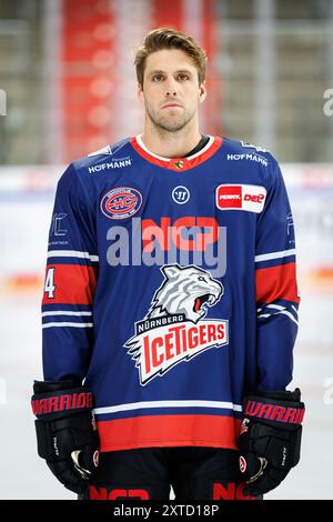 Cole Maier (Nuremberg Ice Tigers, #14) in front of Adam Brooks (EHC Red ...