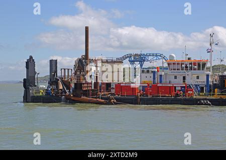 A cable laying barge installing a high voltage, sub-sea cable between ...