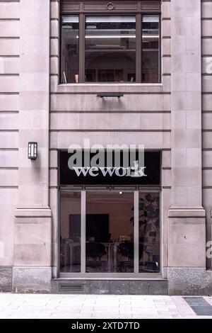 WeWork logo on a building exterior. Provider of co-working office ...