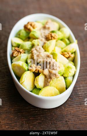 Souffle dish with cooked Brussels sprouts with walnuts and a lemon ...
