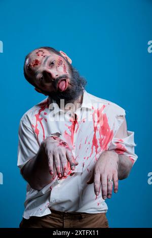 Portrait of evil zombie with limp hands and face mask ready to attack ...