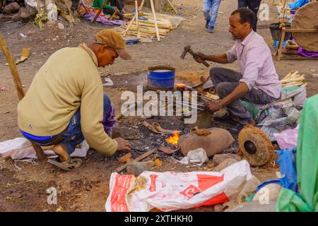 A traditional Arabic blacksmith working in Katara cultural village ...