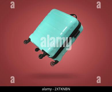 Turquoise suitcase in air on orange background Stock Photo - Alamy