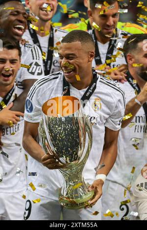 Kylian Mbappe of Real Madrid holds a trophy during the ceremony after the UEFA Super Cup 2024 ...