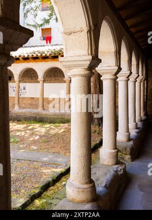 Shaded arched gallery around courtyard at Sant Llorenc de Morunys ...