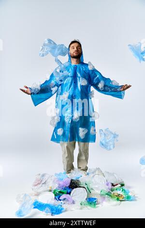 Man in raincoat stands in plastic waste surrounded by bags Stock Photo ...