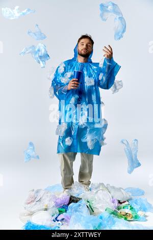 A man stands in a plastic raincoat, surrounded by plastic debris Stock ...