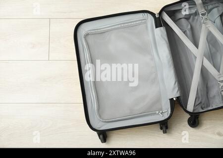 Open empty suitcase on floor indoors, top view. Space for text Stock ...