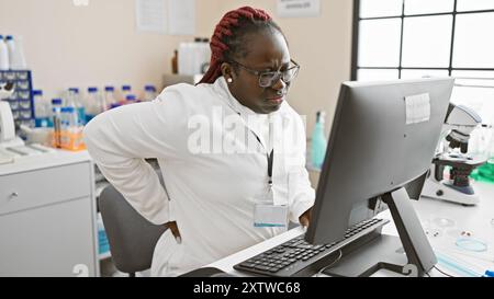Black woman with braids working at pain recovery clinic shooting and ...