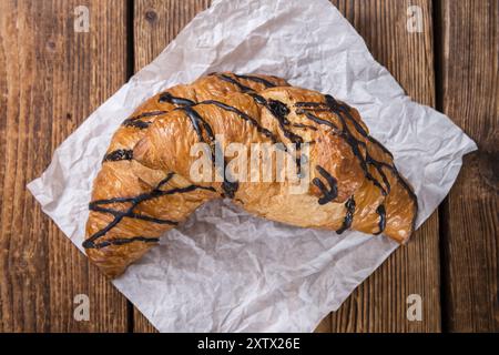 Fresh made Chocolate Croissants (close-up shot) on wooden background ...