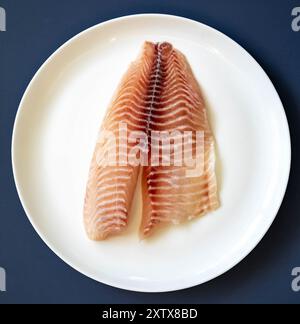 Fillet of tilapia or Saint Peter fish Oreochromis niloticus. Isolated ...