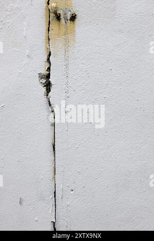 Cracked grey concrete surface with visible reinforcement, Rust in ...