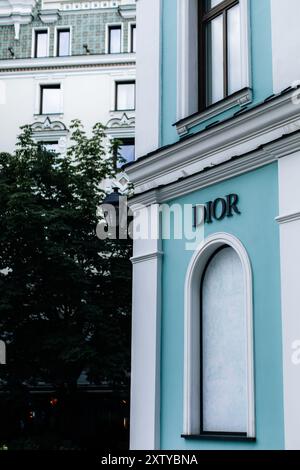 Turquoise facade of fashion boutique with Dior logo. Christian Dior is ...