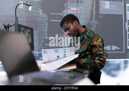 Military team manages cybersecurity operations in a high tech control ...