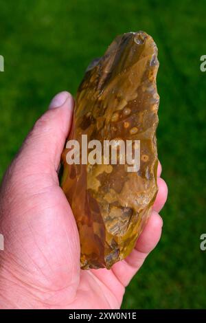 Stone tool. Ancient palaeolithic stone cleaver from the hominid (early ...