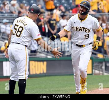 Seattle Mariners third base coach Kristopher Negron, left, greets first ...