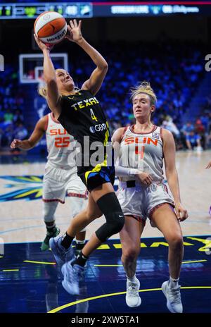 Connecticut Sun guard Jacy Sheldon (4) drives the ball past Washington ...