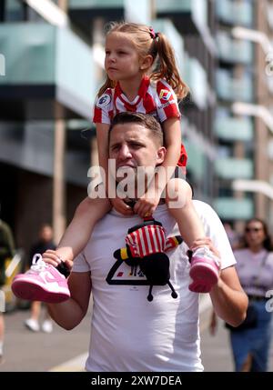 Brentford fans arrive at the ground ahead of the Premier League match ...