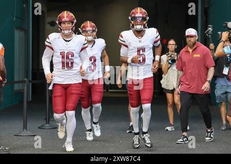 Washington Commanders quarterbacks Jayden Daniels, left, and Marcus ...