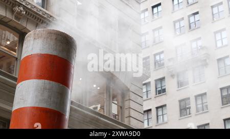 Steam vapor vented on New York City Water street, orange vapour tube ...