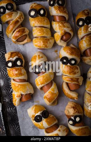Scary sausage mummies in dough with funny eyes on table. Funny ...
