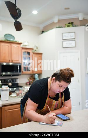 woman writing making list taking notes in notepad working or learning ...