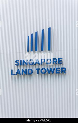 19 Aug 2024. Singapore Land Tower blue logo and signage against a white ...
