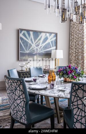 Geometric artwork with similar pattern on dining chairs in luxury ...