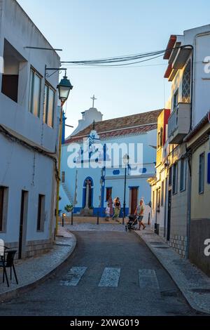 A street in the town of Alvor in the Algarve with bunting hanging Stock ...