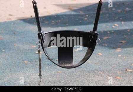 black baby swing on playset Stock Photo - Alamy