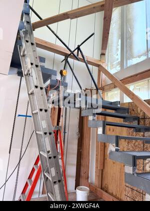 An installation of metal support stairs to second floor is underway in ...