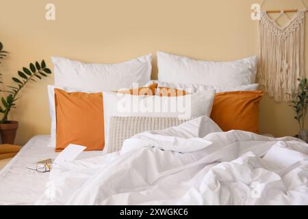 Big comfortable bed with crumpled linen in bedroom Stock Photo - Alamy