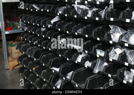 Many plastic boxes for storing car parts in auto store Stock Photo - Alamy